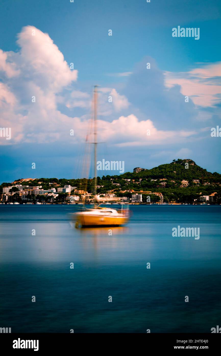 Vertical photo of a lake, a boat and houses on a forest hill in Geneva ...