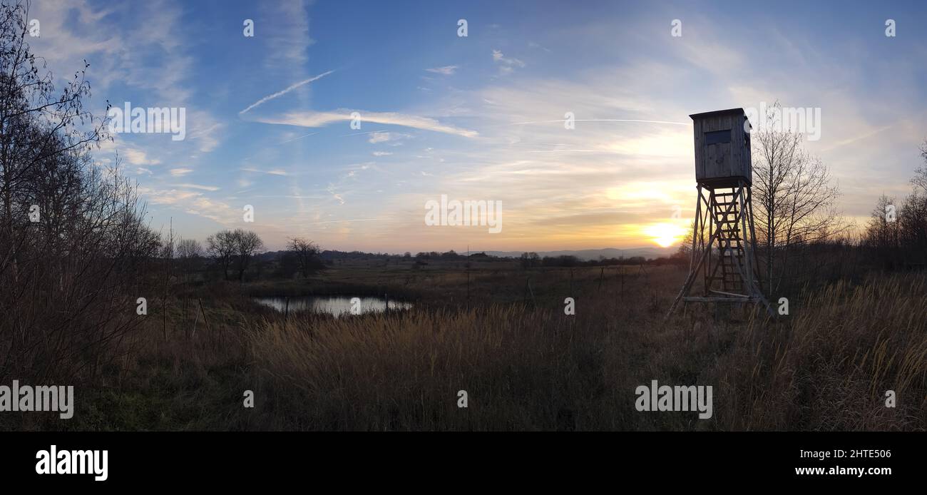 Beautiful view of a field with a lake at sunset Stock Photo - Alamy