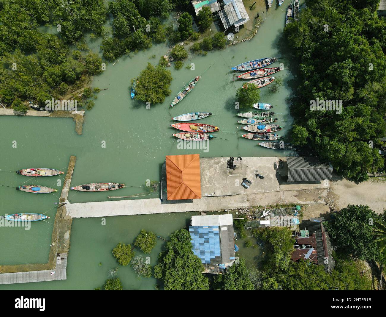 A fishing village in Don Sak District with small houses and anchored ...