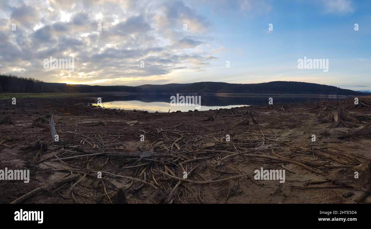 Panoramic shot of a field with a lake at sunset Stock Photo - Alamy