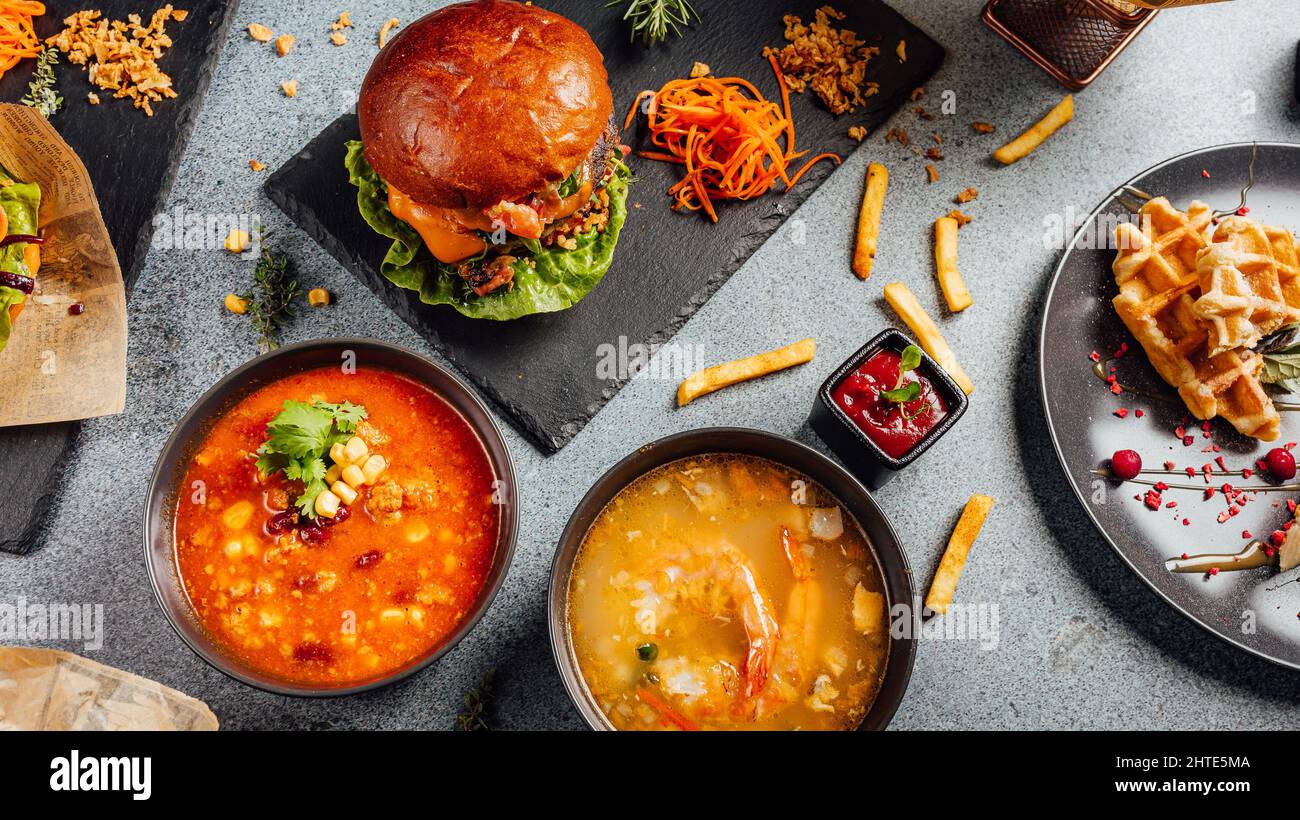 Top view of various food types soups, hamburgers, and other ingredients ...