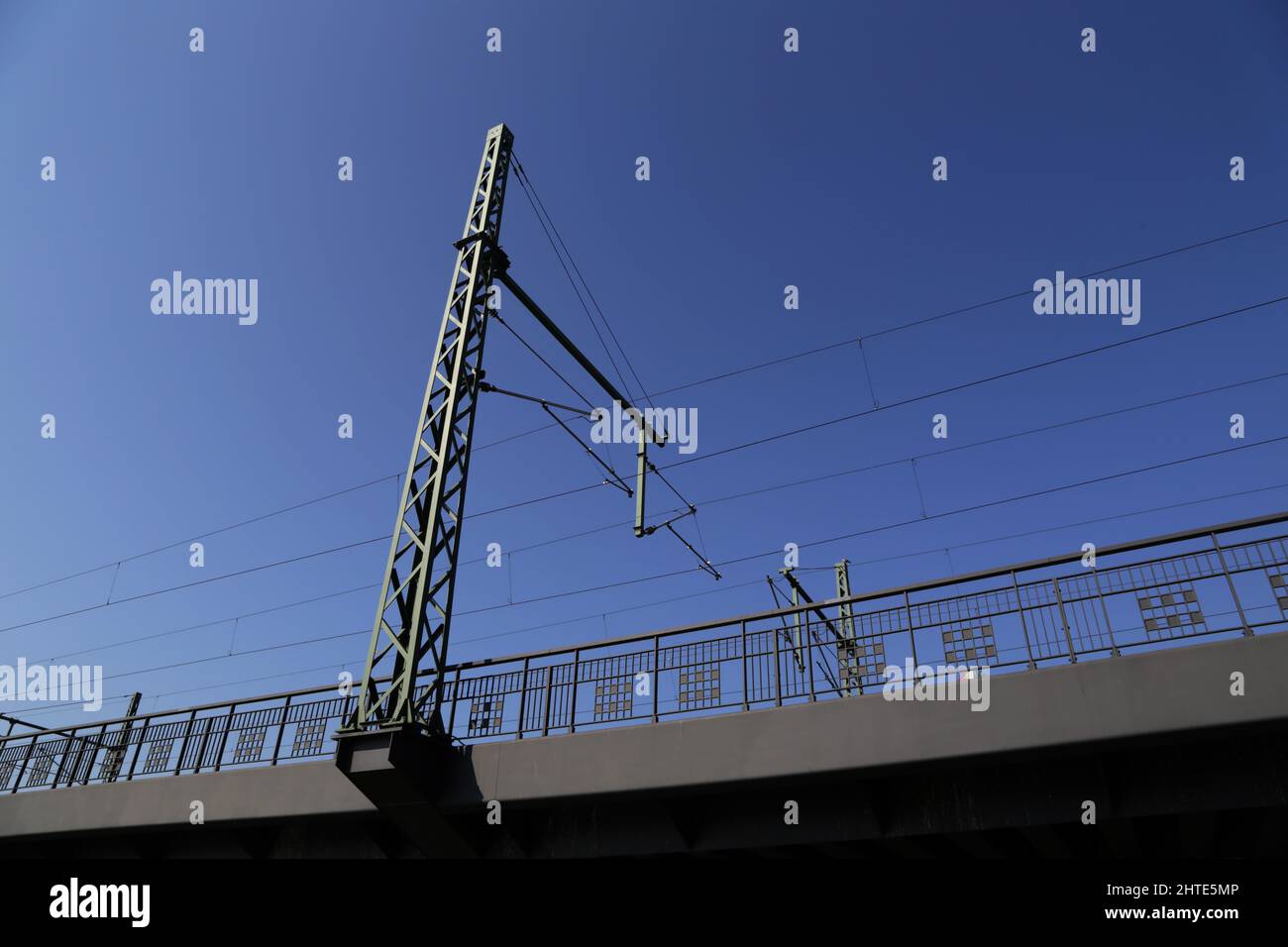 Low-angle shot of a railway overhead line with heavy current against ...