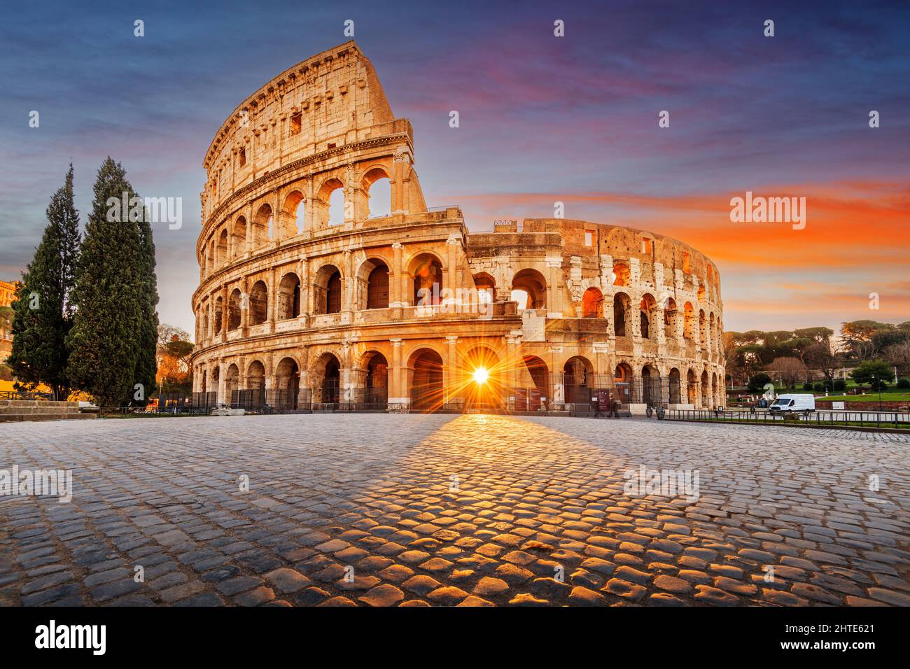 Rome, Italy at the Colosseum Amphitheater with the sunrise through the ...