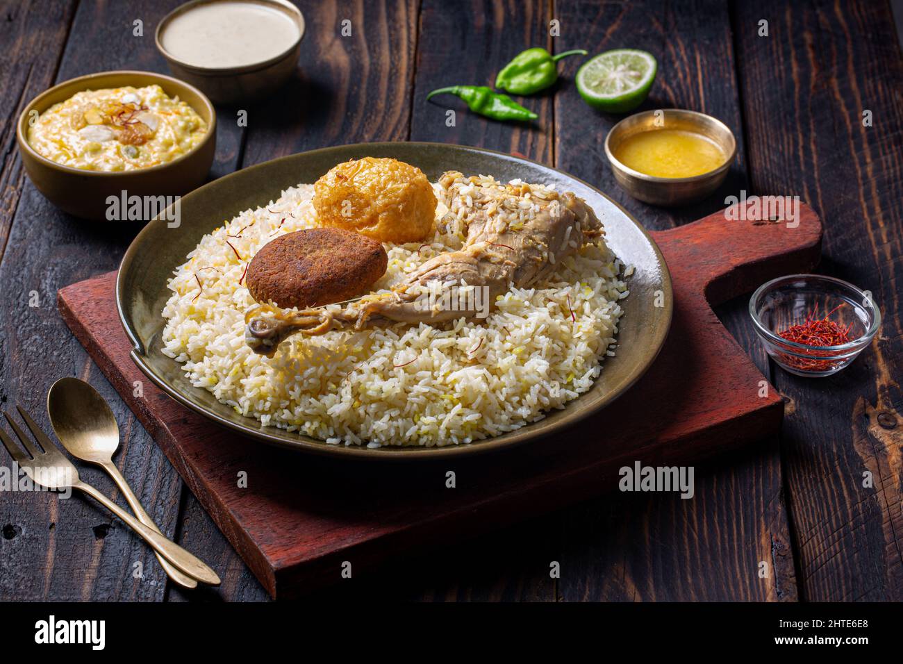 Close up shot of the famous Indian biryani dish with fork and spoon ...