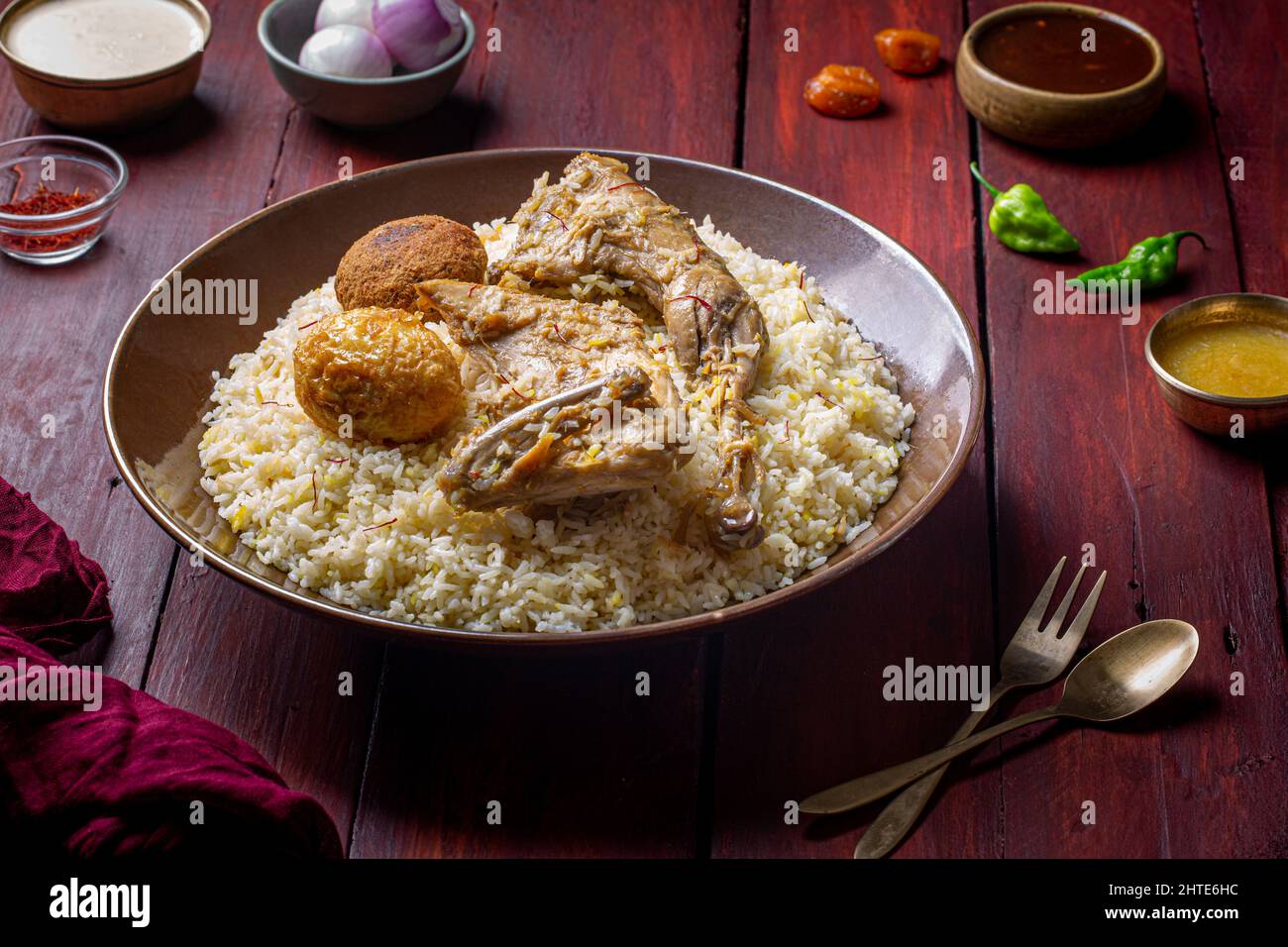 Close up shot of the famous Indian biryani dish with fork and spoon ...