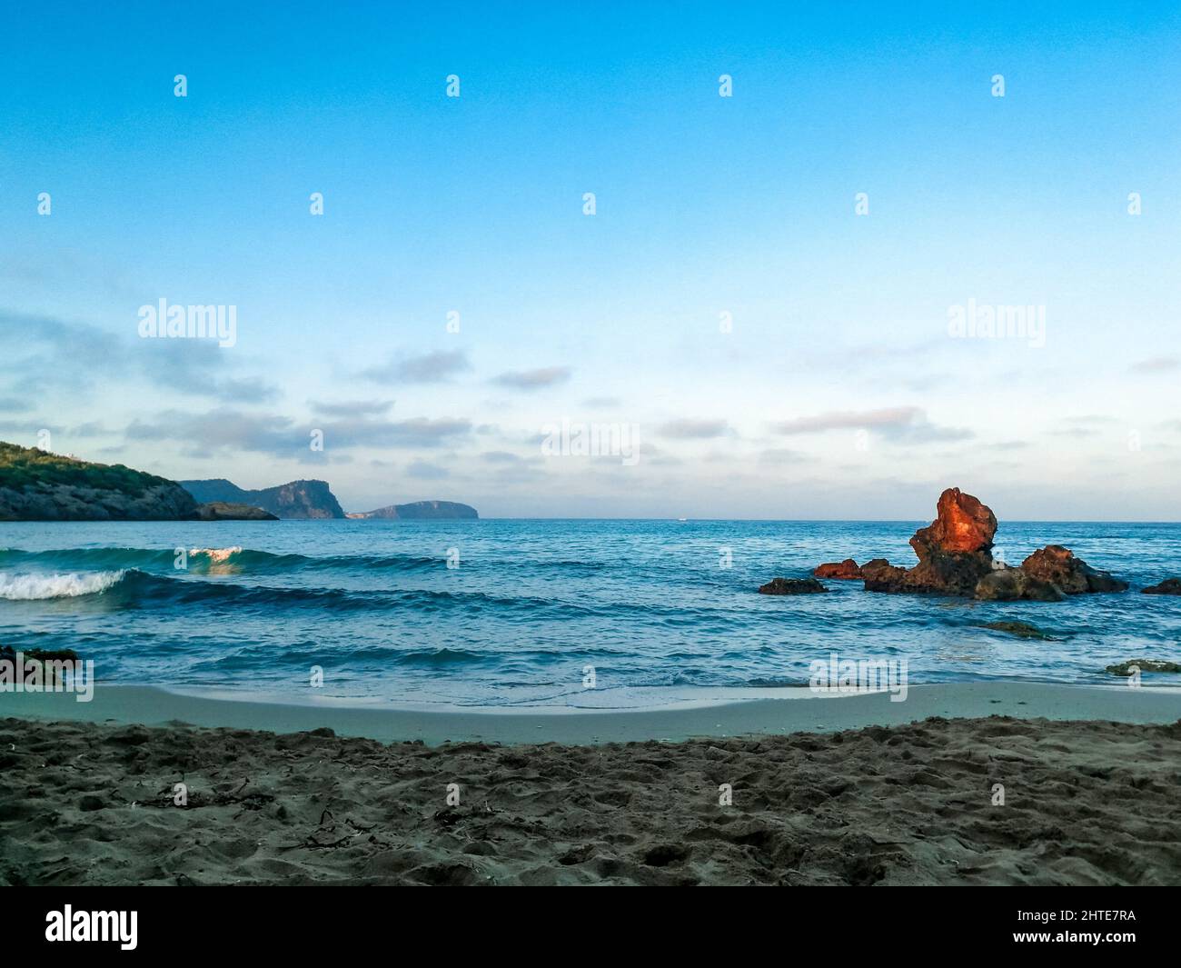 Beautiful scene of water in the sea with a cloudy blue sky near the ...