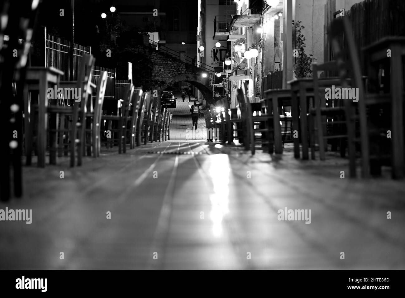 Grayscale urban scenery of the street cafe at night Stock Photo - Alamy