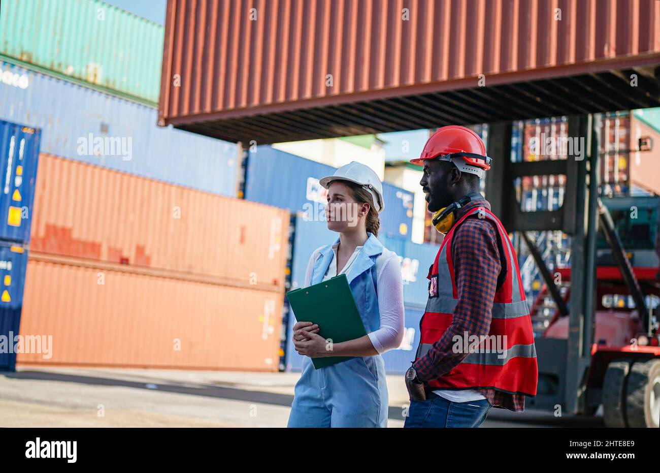 Foreman control Industrial Container Cargo freight ship at industry ...