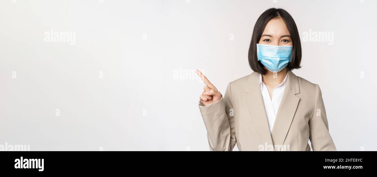 Coronavirus and work concept. Portrait of woman in medical face mask ...