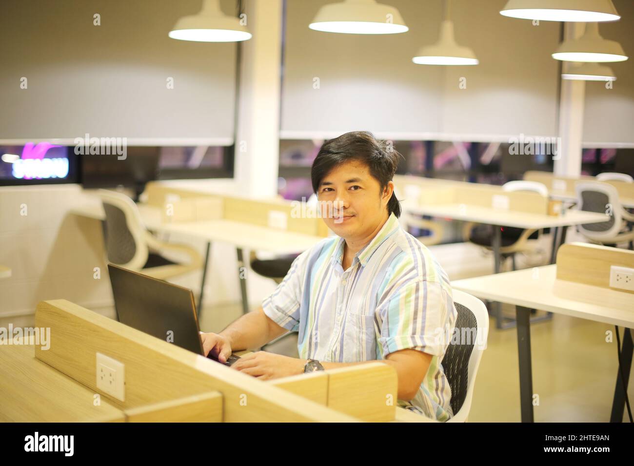 Portrait of male freelancer while working remotely at modern laptop ...