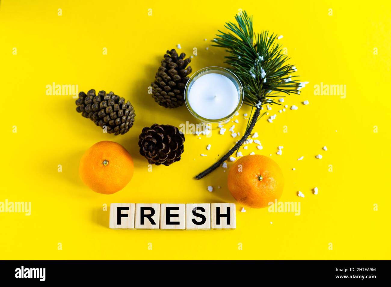 Word fresh on wooden blocks on a yellow background with tangerine ...