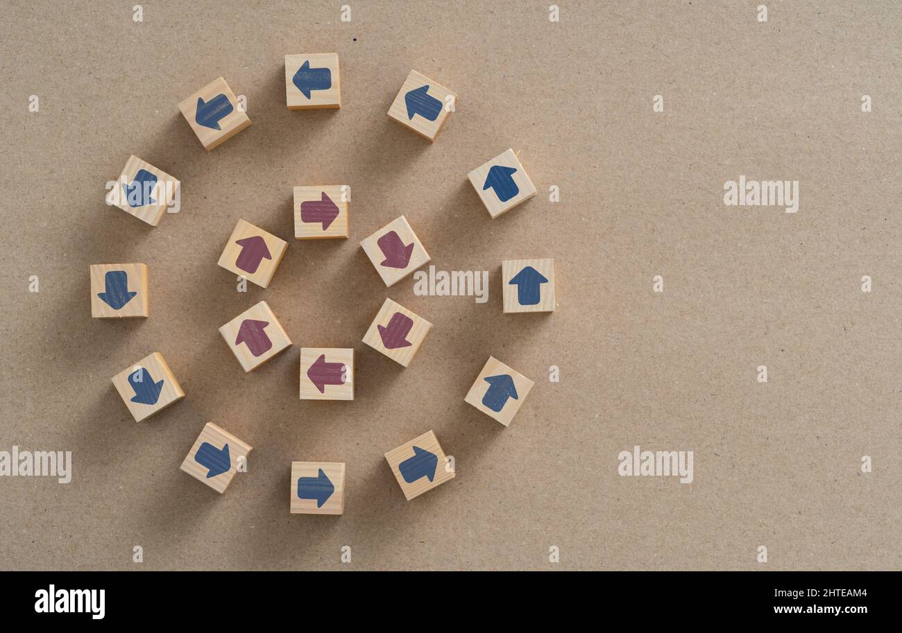 Top view photo of wooden blocks with arrows pointing opposite direction ...