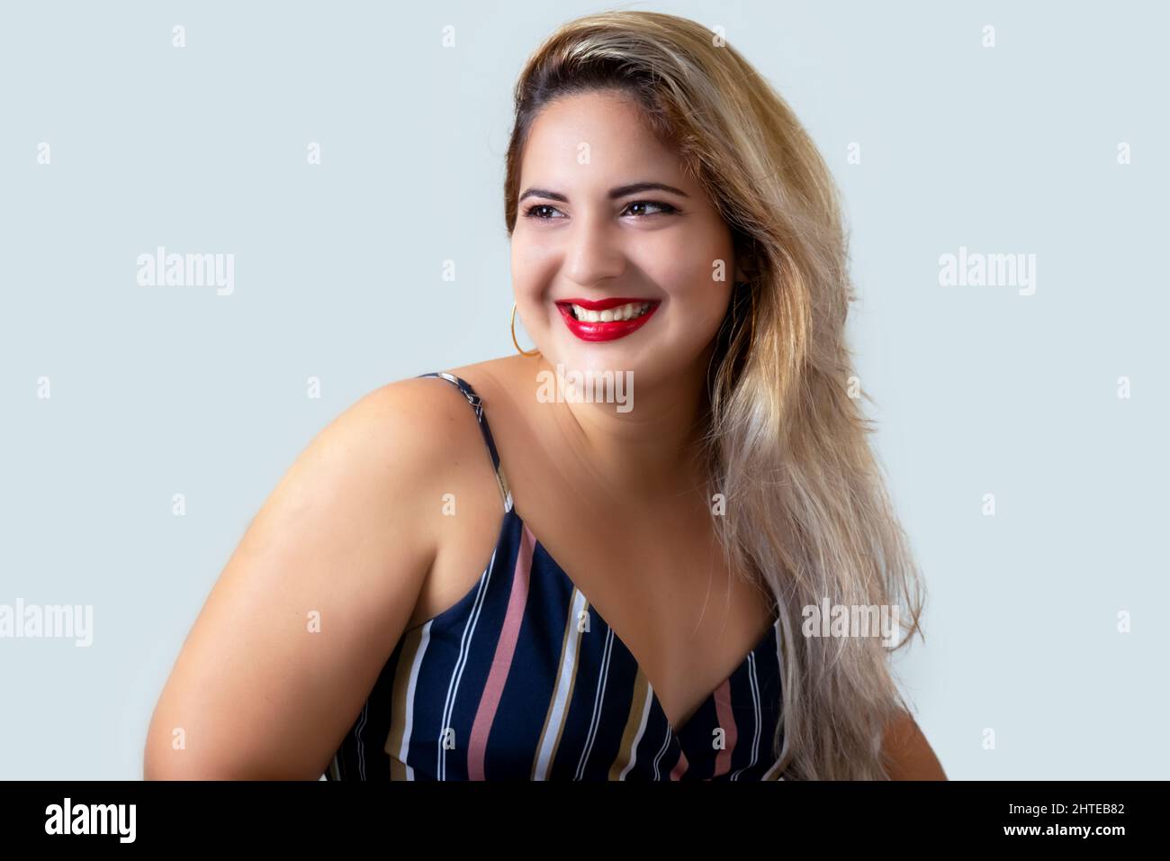 Portrait of a young slightly overweight woman with a smile on her face ...