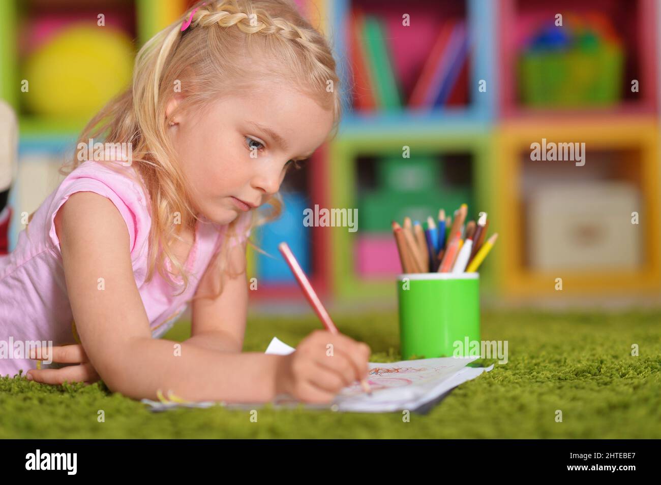 Portrait of cute little girl drawing at home Stock Photo - Alamy