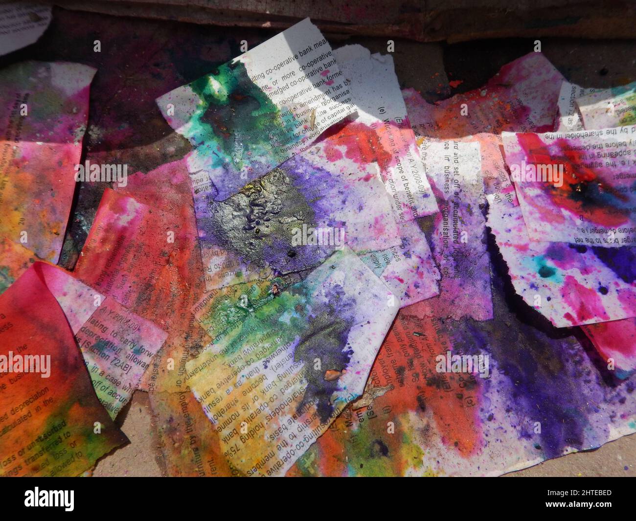 Papers on the ground covered with colors, celebrating the Holi Hindu ...