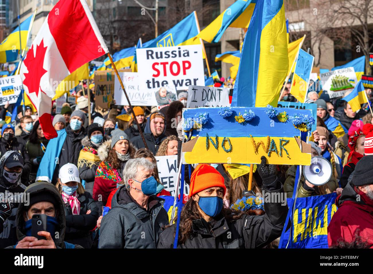 Toronto, Canada - February 27, 2022: A Canadian flag amid a crowd of ...
