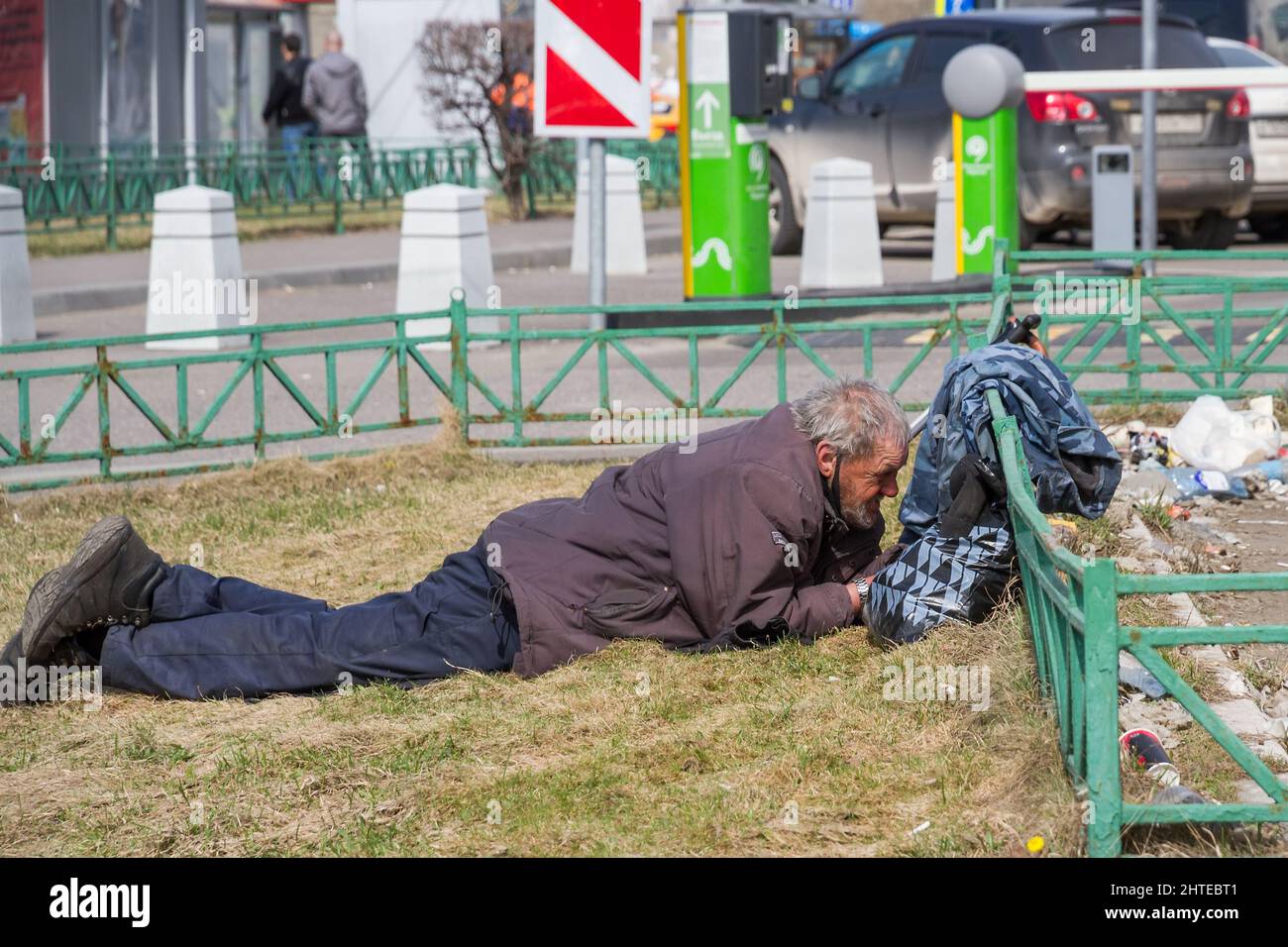 Russia. Moscow. Daily life of the city. An elderly homeless man lies on ...