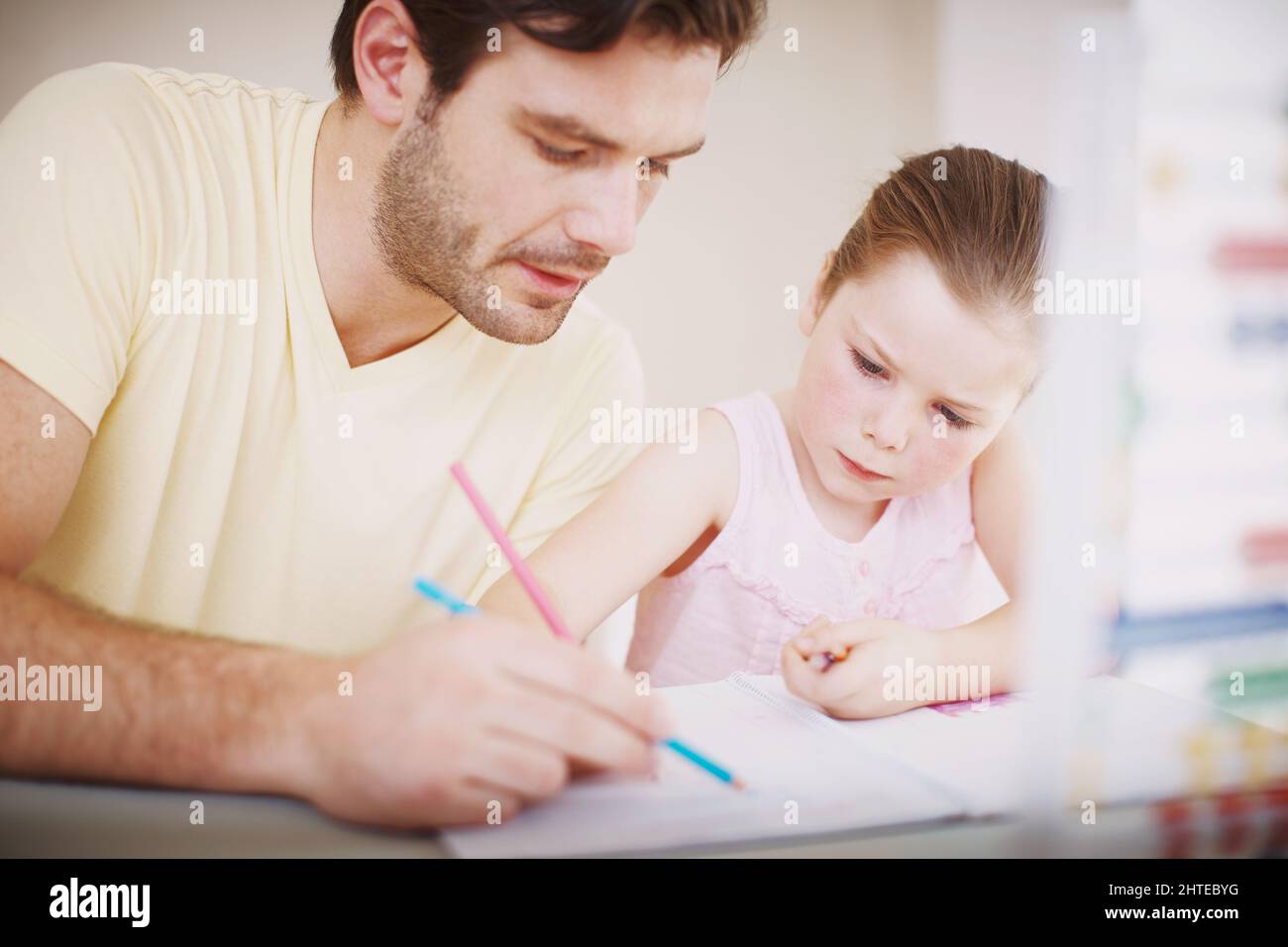 She always does her homework. Cropped shot of a little girl doing her ...