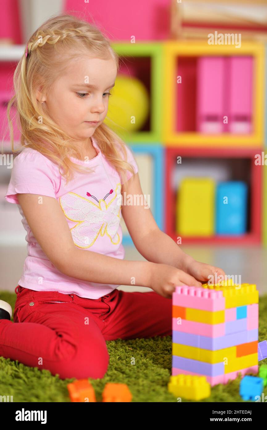 Happy cute little girl playing with cubes Stock Photo - Alamy