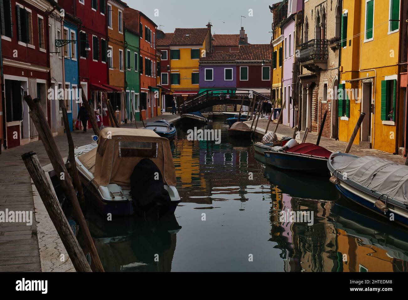 Canal between colored buildings with boats on its both sides, Burano ...