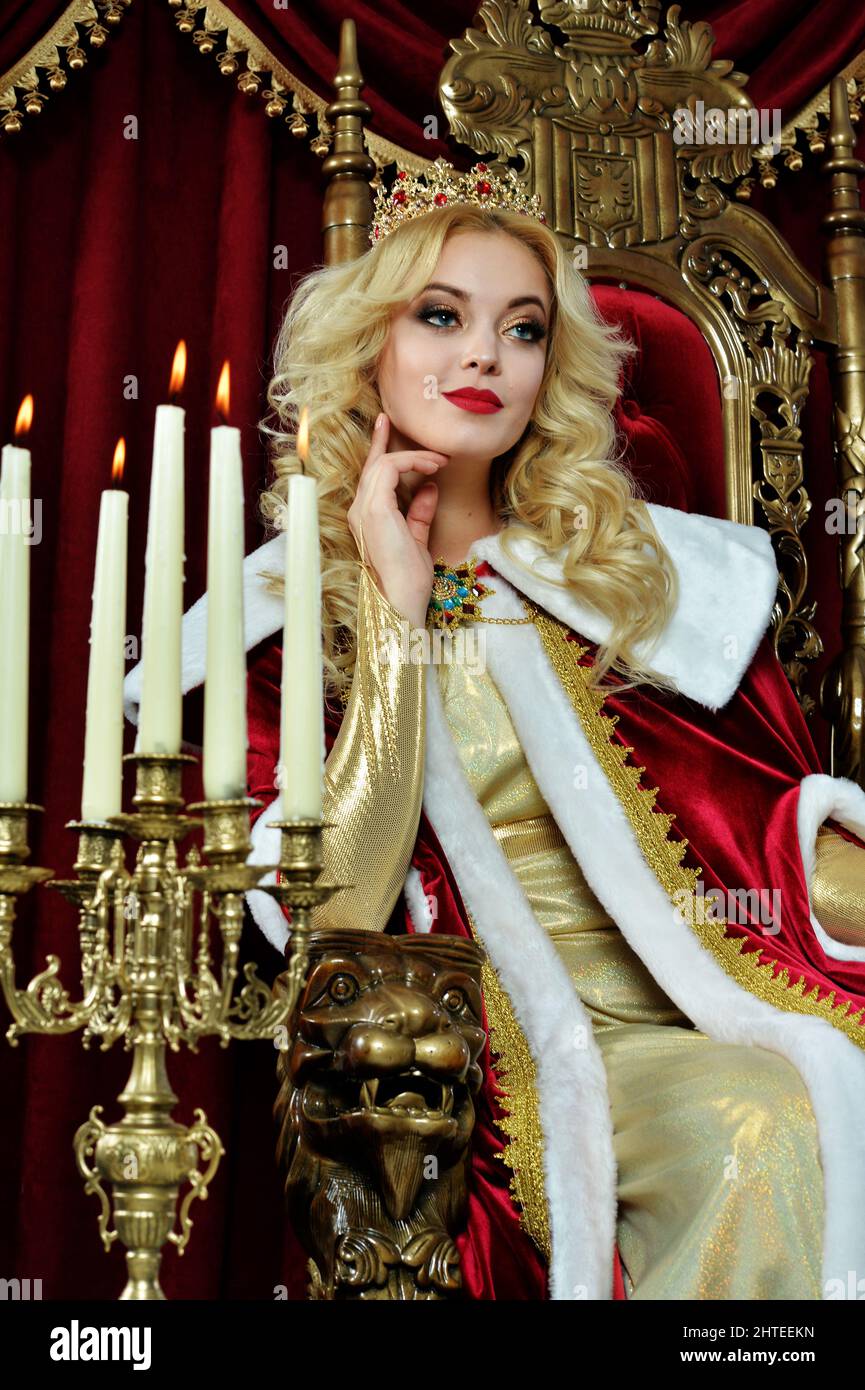 Portrait of queen with crown on chair Stock Photo - Alamy