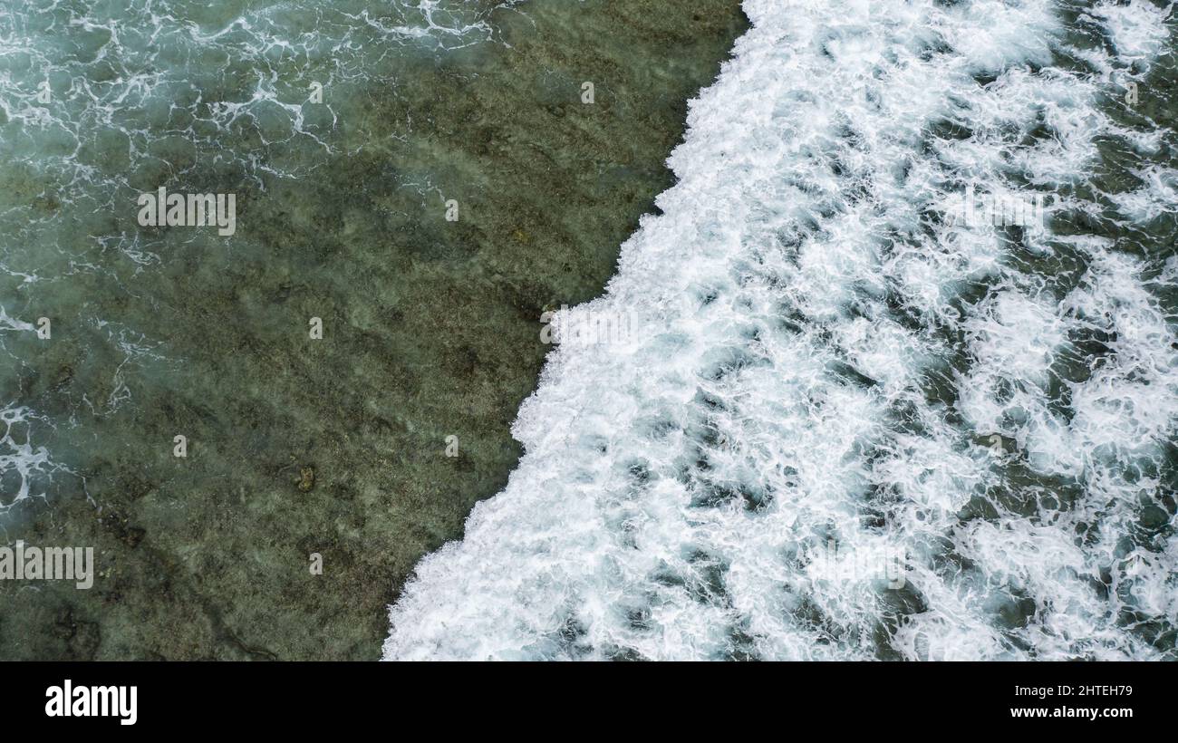 An aerial view of the huge waves crossing the clear tranquil surface of the water Stock Photo ...
