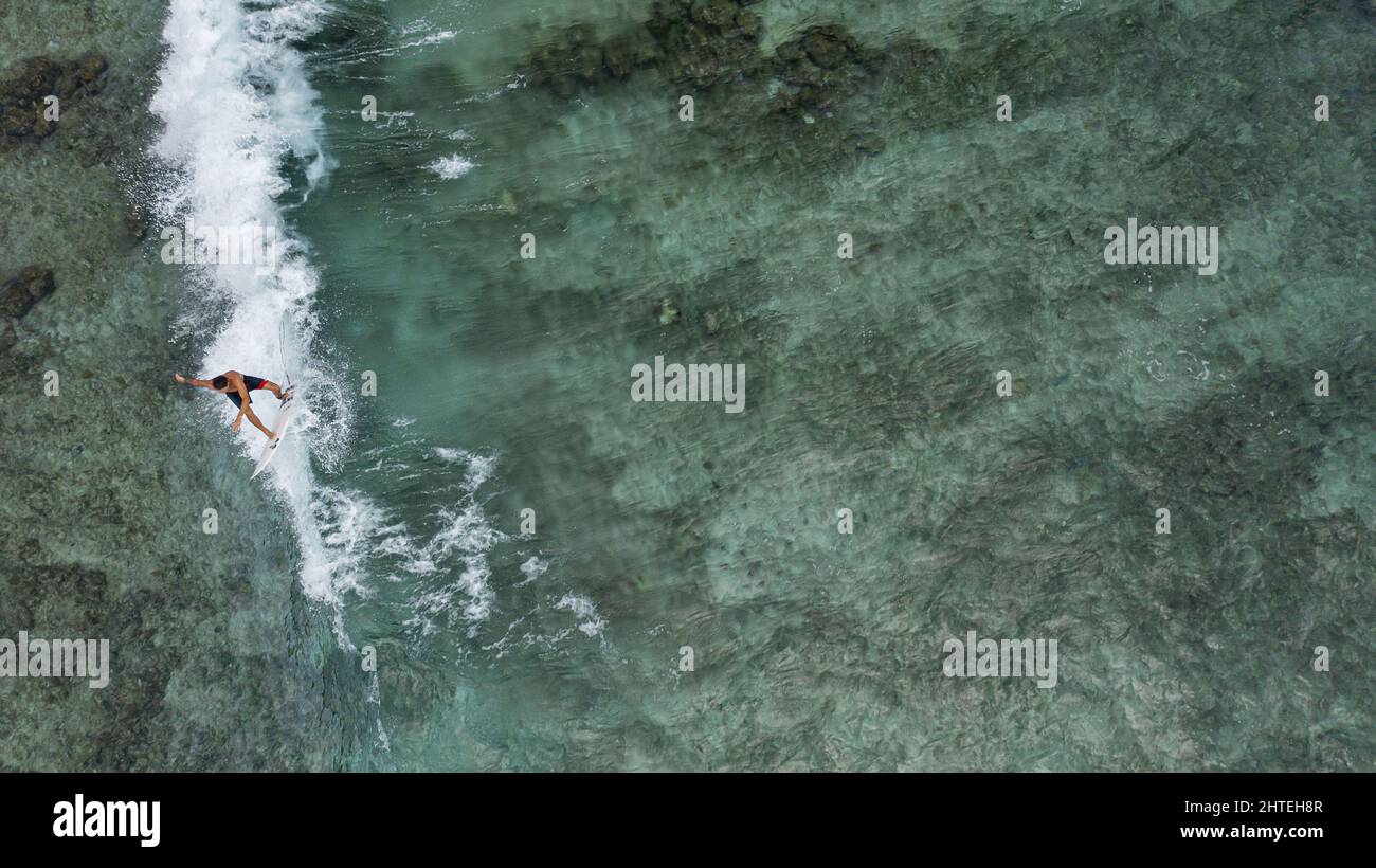 Aerial view of a male surfer riding the huge waves Stock Photo - Alamy