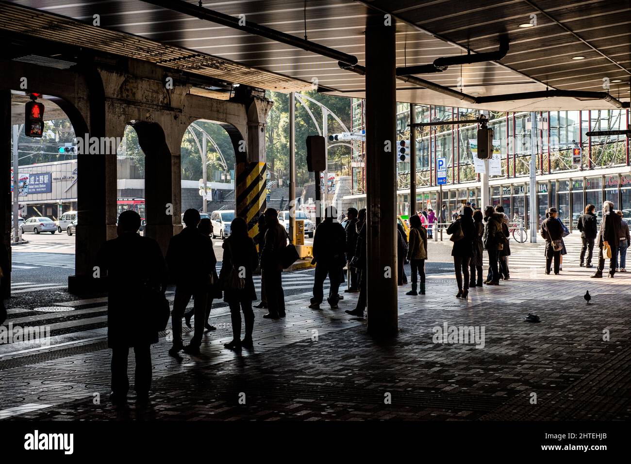 Group of passengers waiting for the walk signal outside Ueno Station in ...