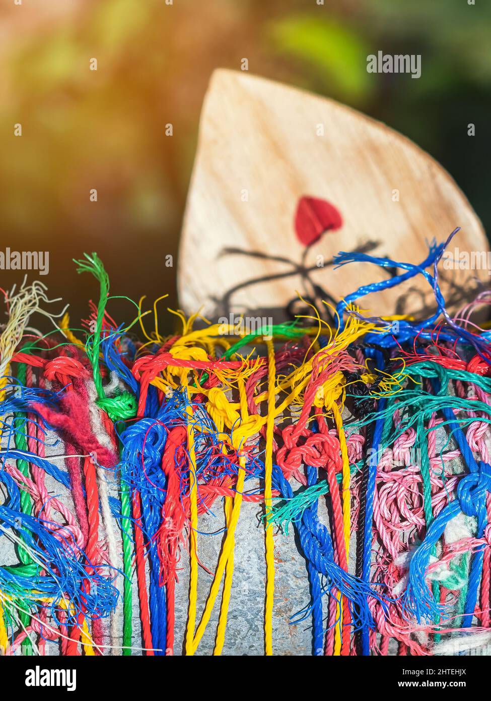 Many suspended chaotically intertwined colorful ropes tied into messy ...