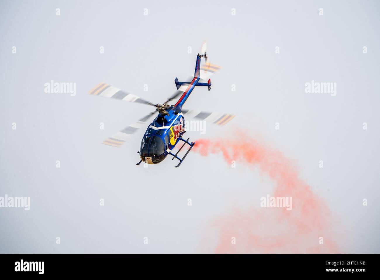 Helicopter with pink smoke Stock Photo - Alamy