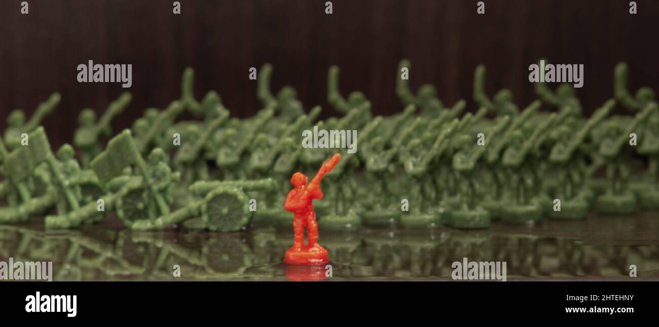 Small red soldier miniature with the blurred background of other green ...