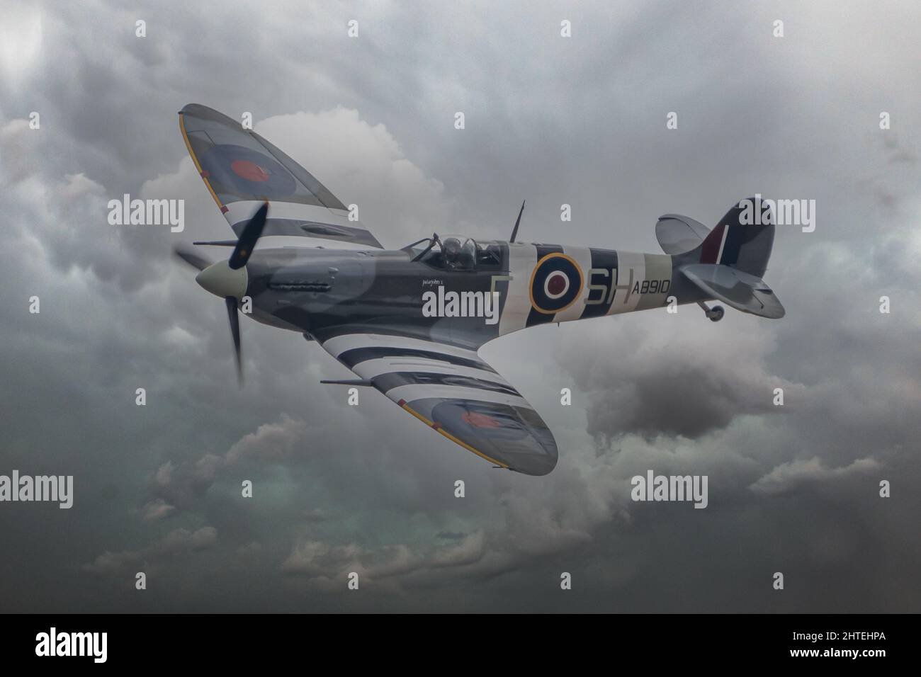 View of the World War 2 Spitfire Plane in the cloudy sky Stock Photo - Alamy