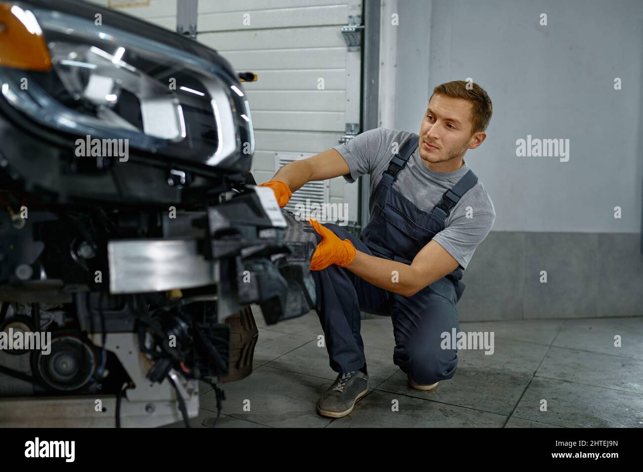 Auto mechanic worker working at car maintenance Stock Photo - Alamy