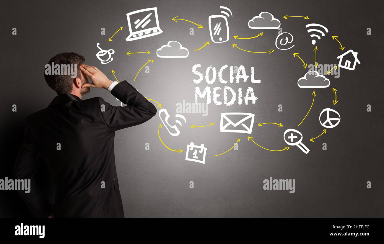 businessman drawing social media icons Stock Photo - Alamy