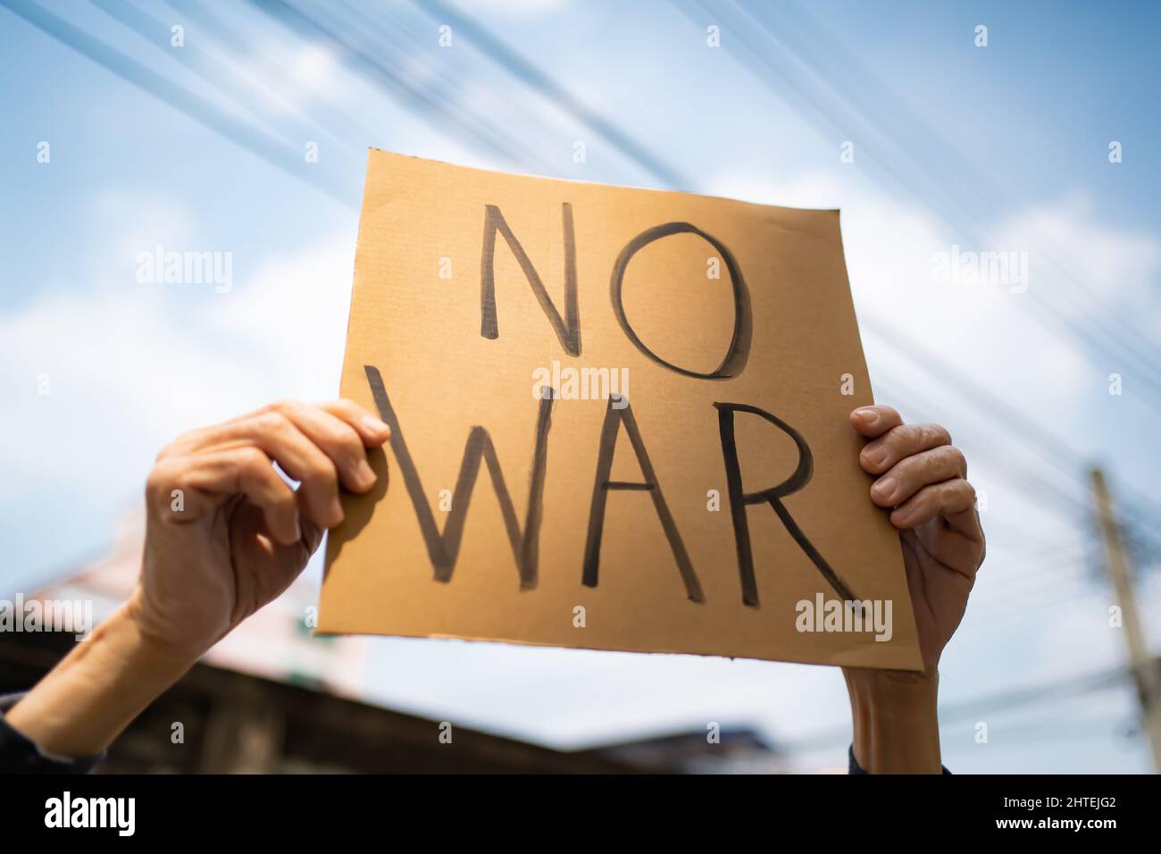 Demonstrator holding "No War" placard Stock Photo - Alamy