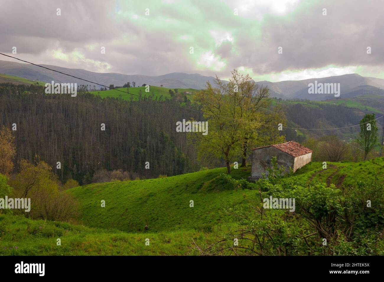 View of the small house in the valley with mountains in the background ...