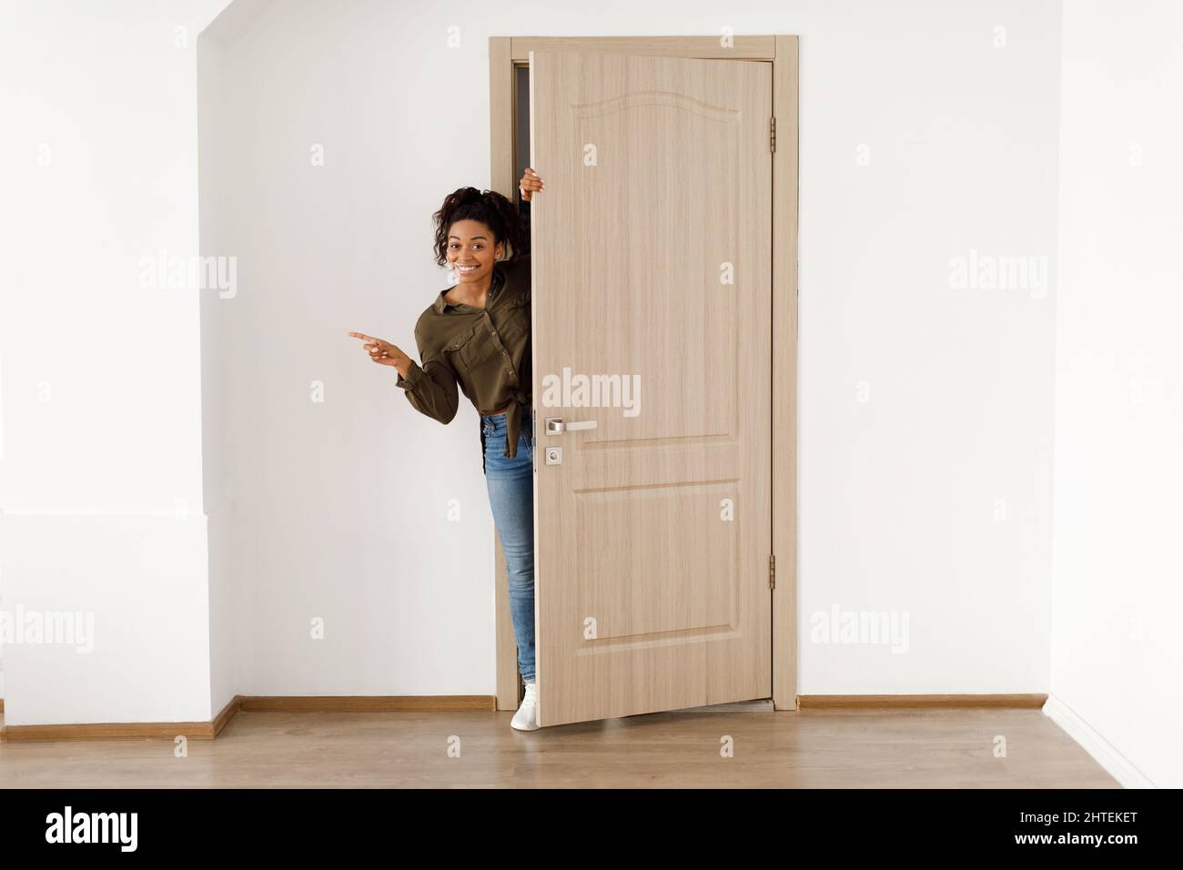 Woman pointing to door hi-res stock photography and images - Alamy