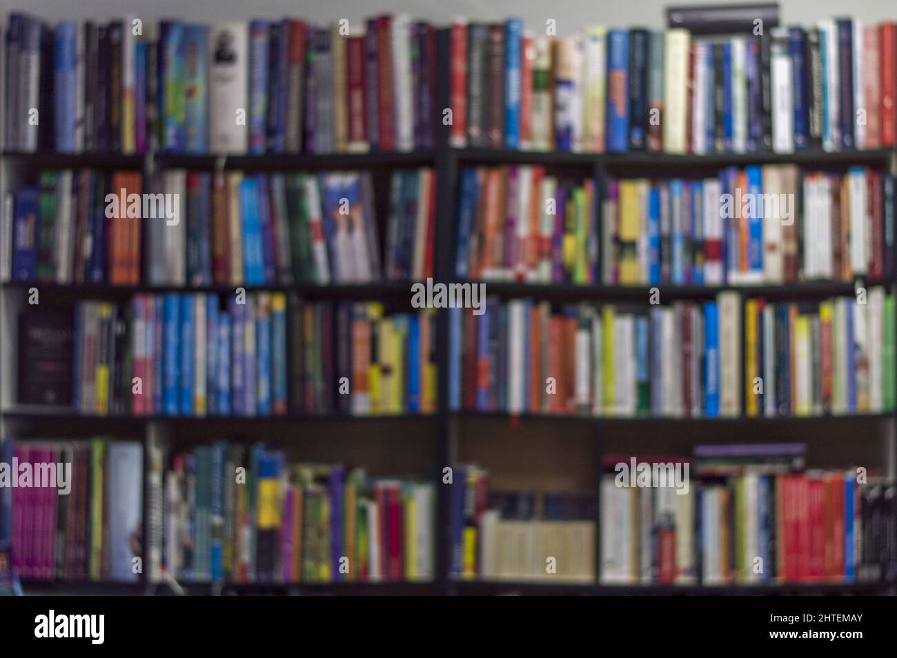 Blurred view of a large bookshelf with different books Stock Photo - Alamy