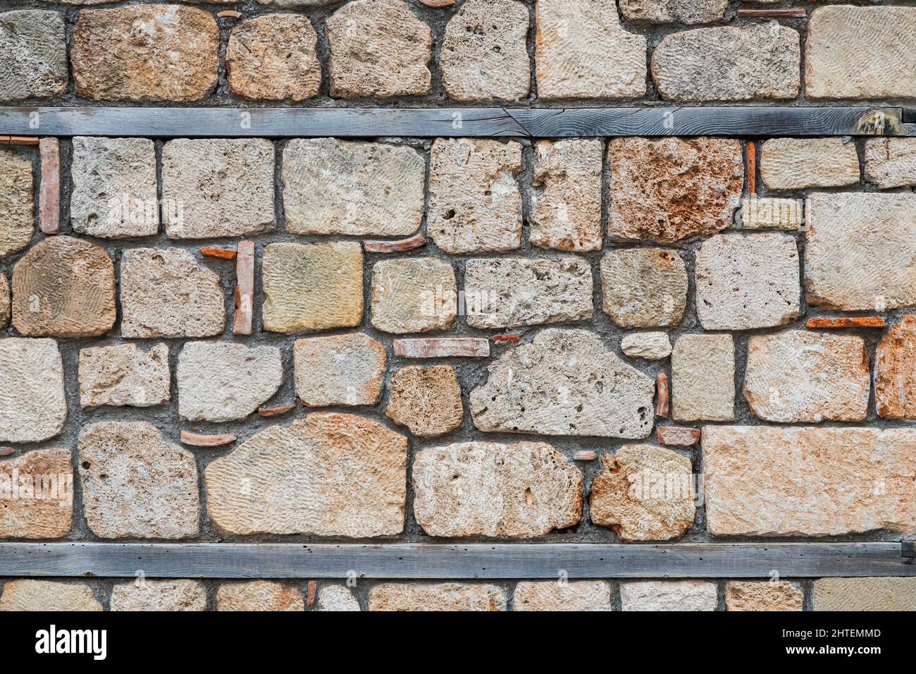 The antique wall is paved with gray stones, top view. stone texture ...