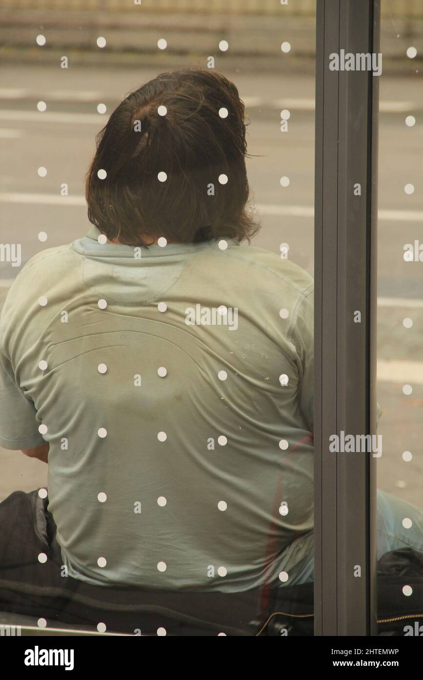 Photo of a person laying their back against a doted glass window Stock ...