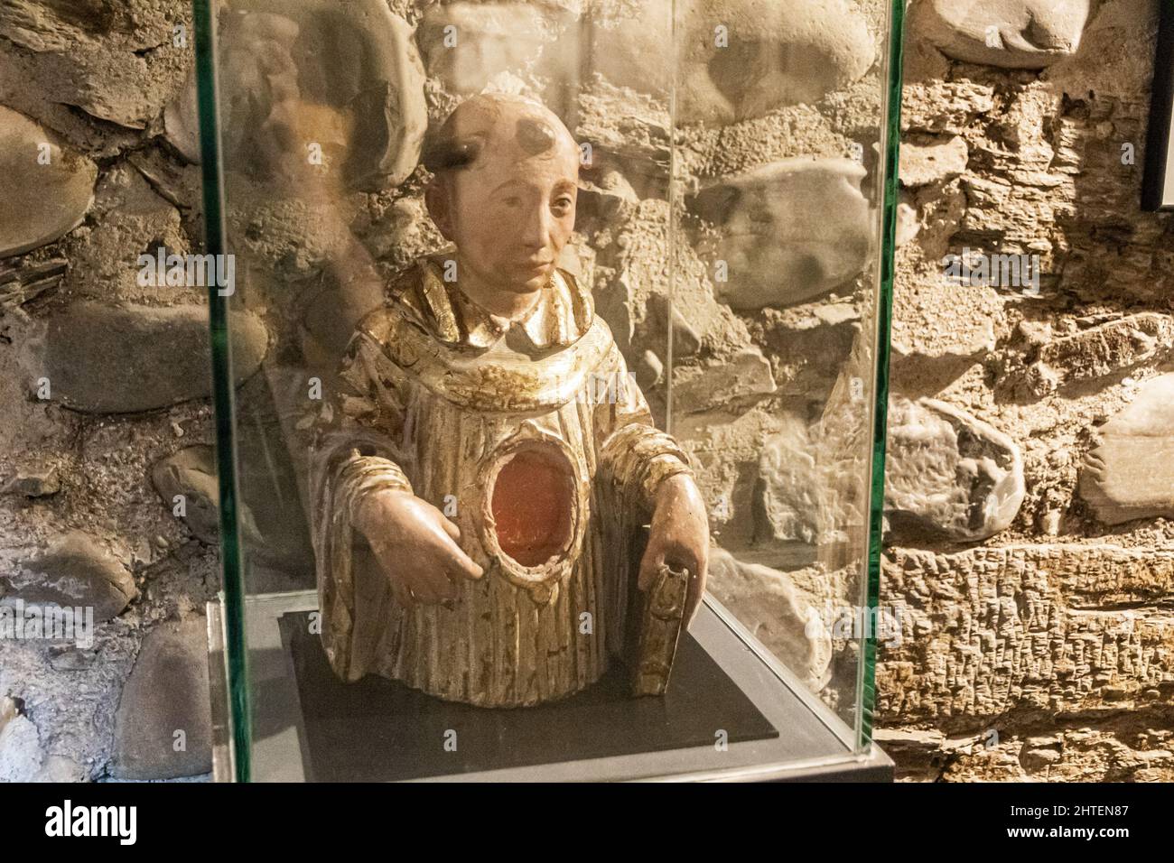 Reliquary sculpture of a saint in glass display box inside the ...