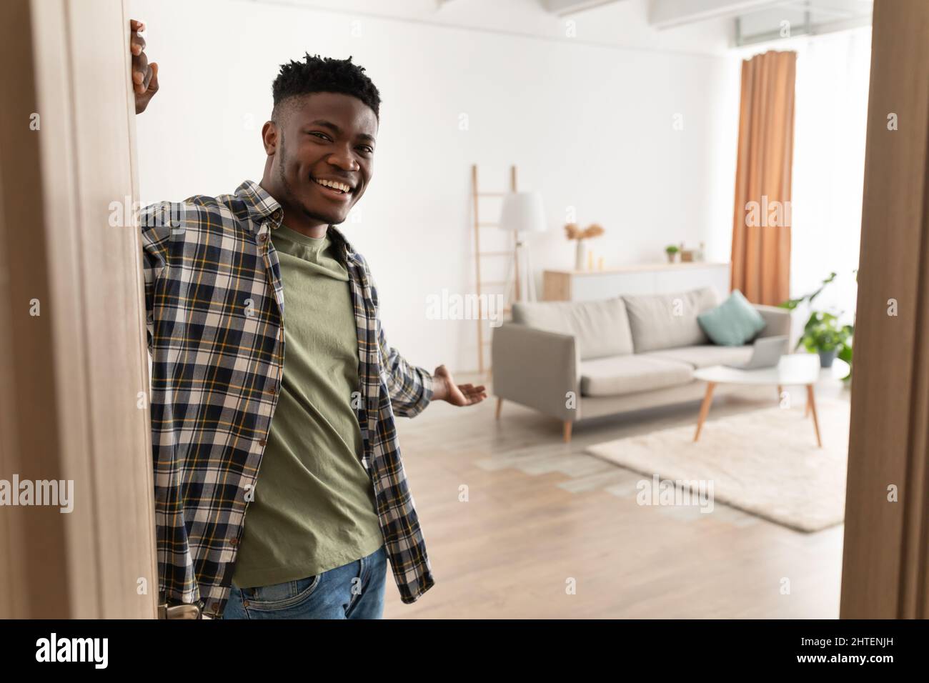 Black Man Opening Door Gesturing Inviting To Come In Indoor Stock Photo ...