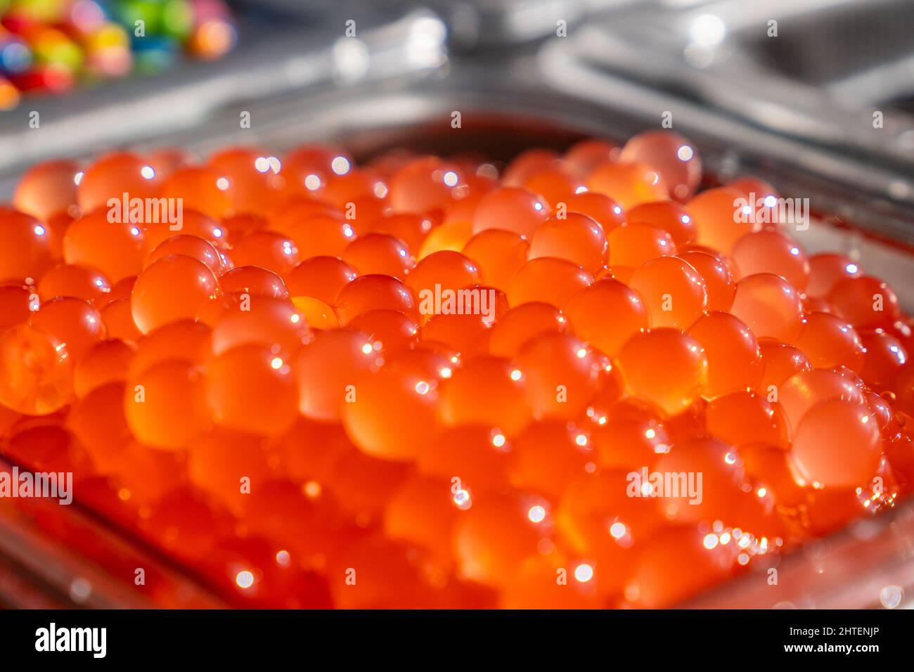 Bunch of red bobas with a flavor of pomegranate in a shop. Ingredient ...