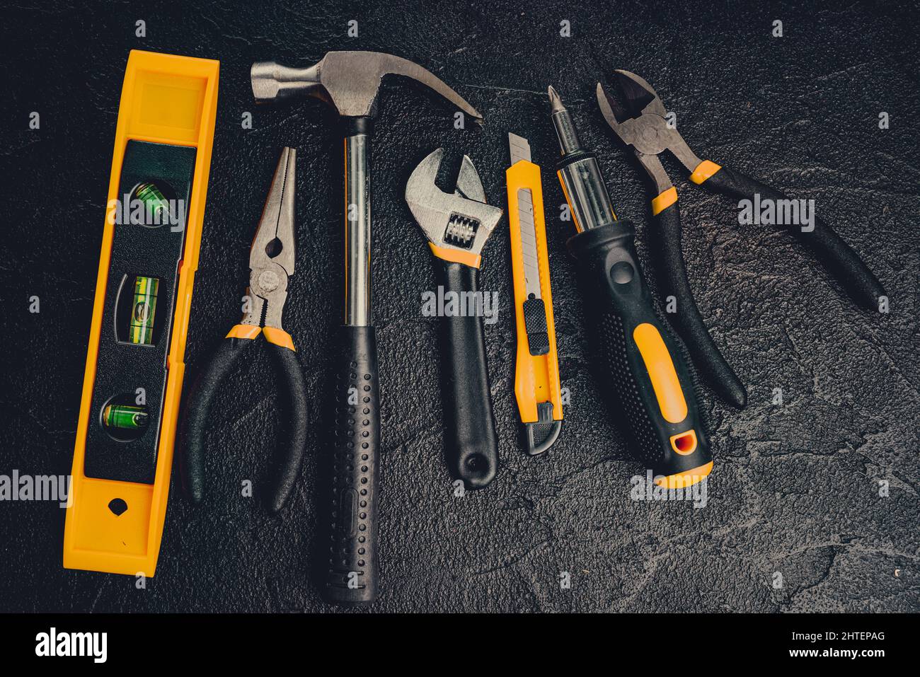 Tools for master builder on a black background Stock Photo - Alamy