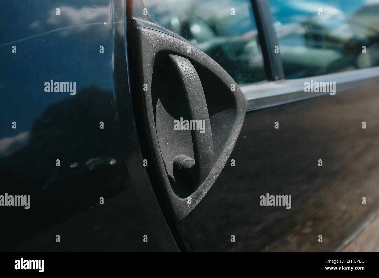 Handle of an automatic sliding door of a black van Stock Photo - Alamy
