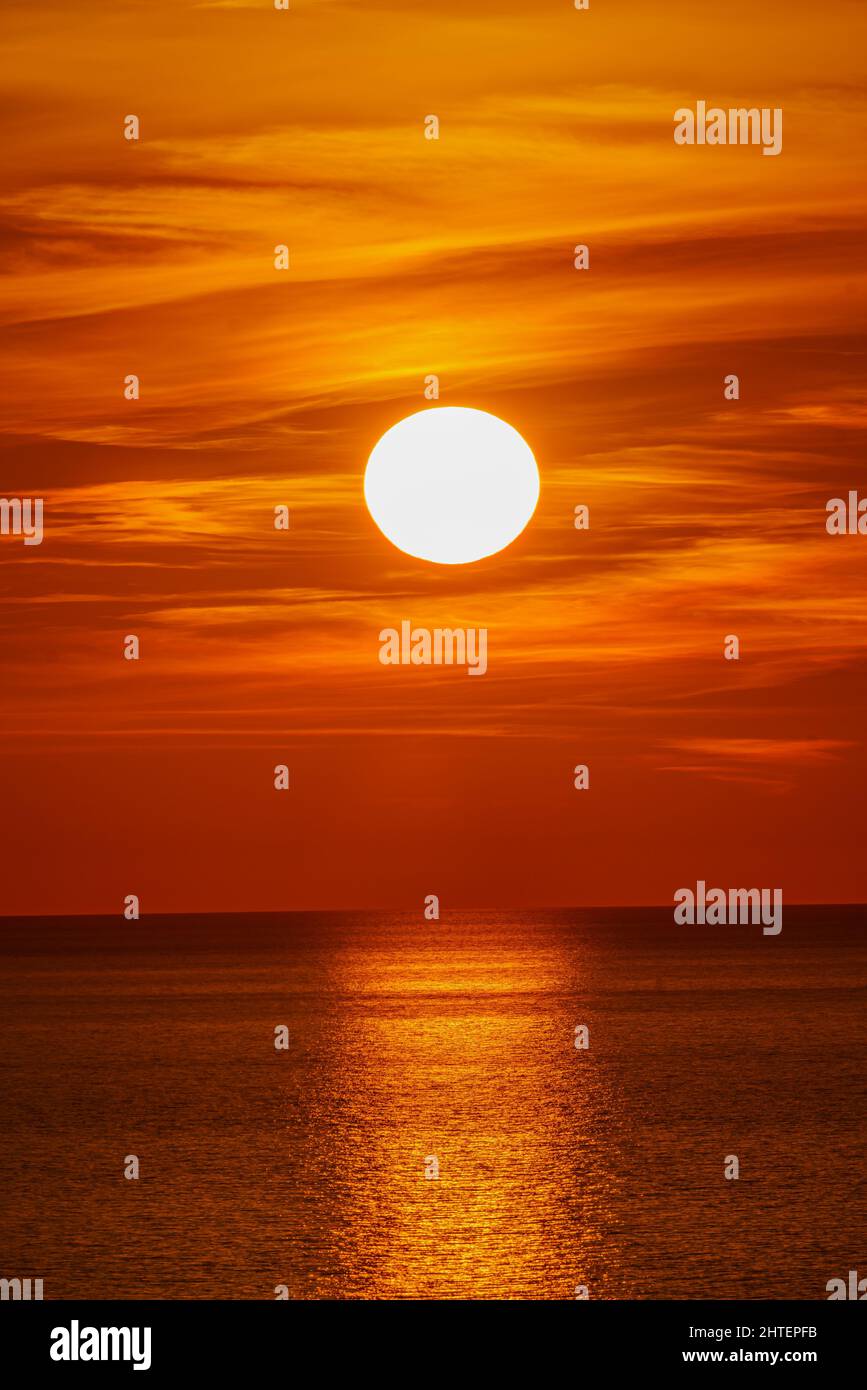 Fantastic sunset over ocean. The sun goes down over the sea. Dramatic ...