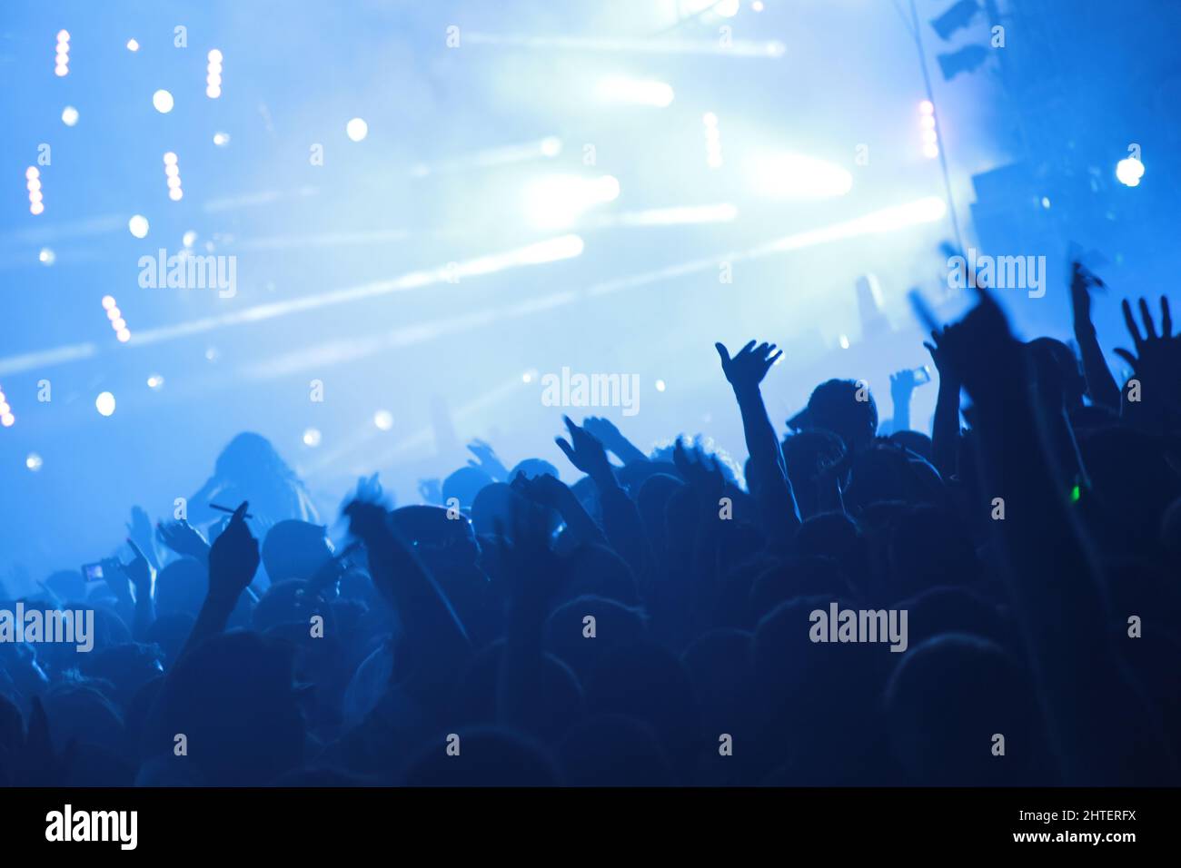 View of people with their hands up hanging out and enjoying the music ...