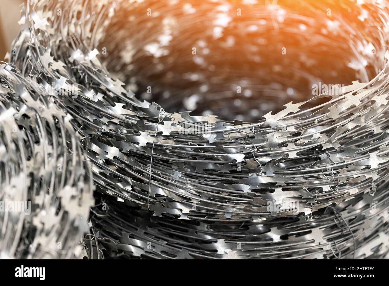 A coil of new steel barbed wire in close-up. Advertising background ...
