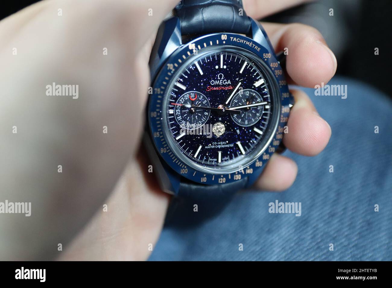 Closeup of a Hand holding an Omega Speedmaster Stock Photo - Alamy