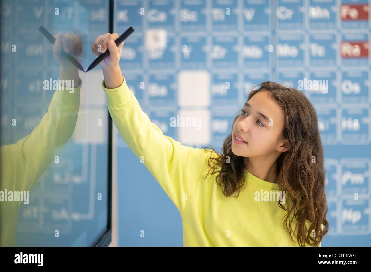 Girl drawing with marker on blackboard in classroom Stock Photo - Alamy